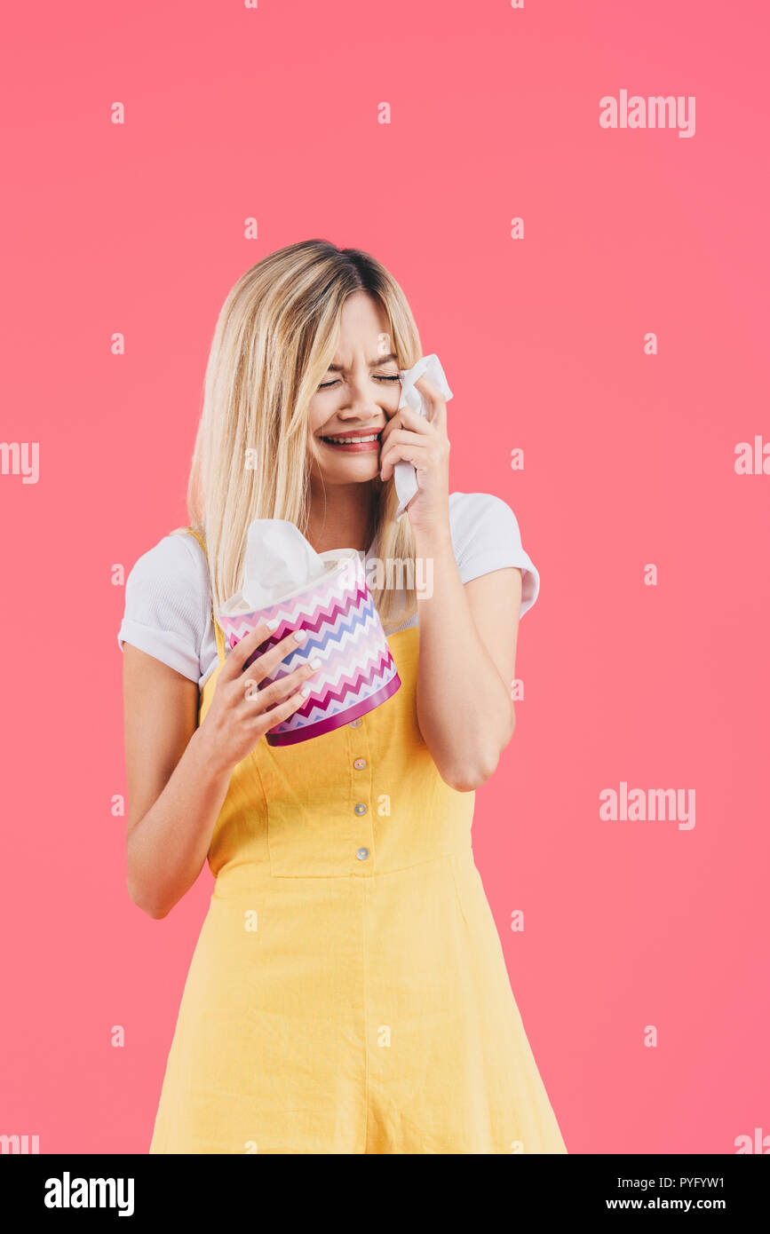 crying young woman with tissue box wiping tears isolated on pink Stock ...