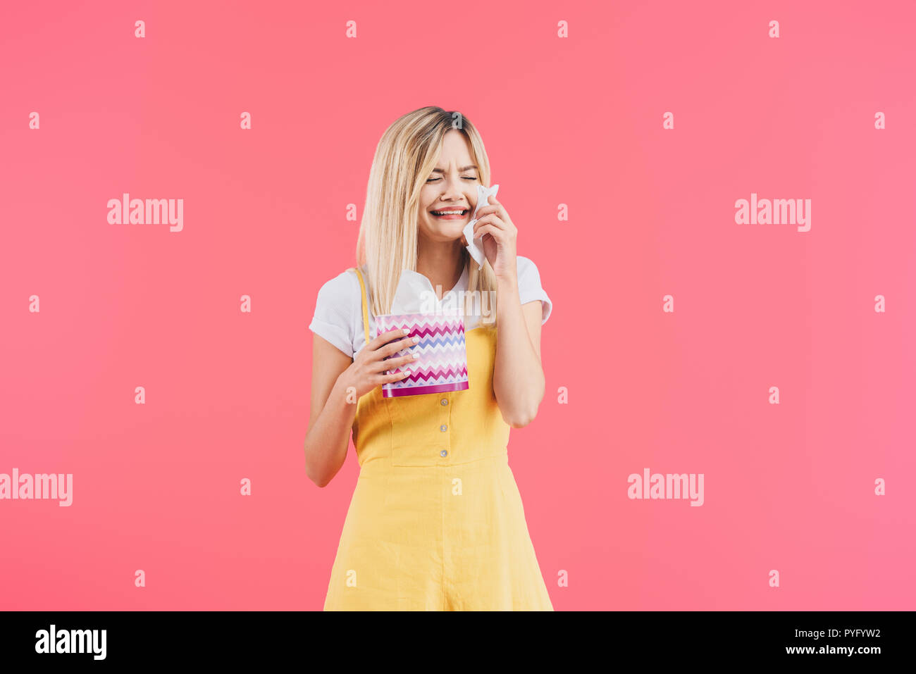 emotional young woman with tissue box crying and wiping tears isolated ...