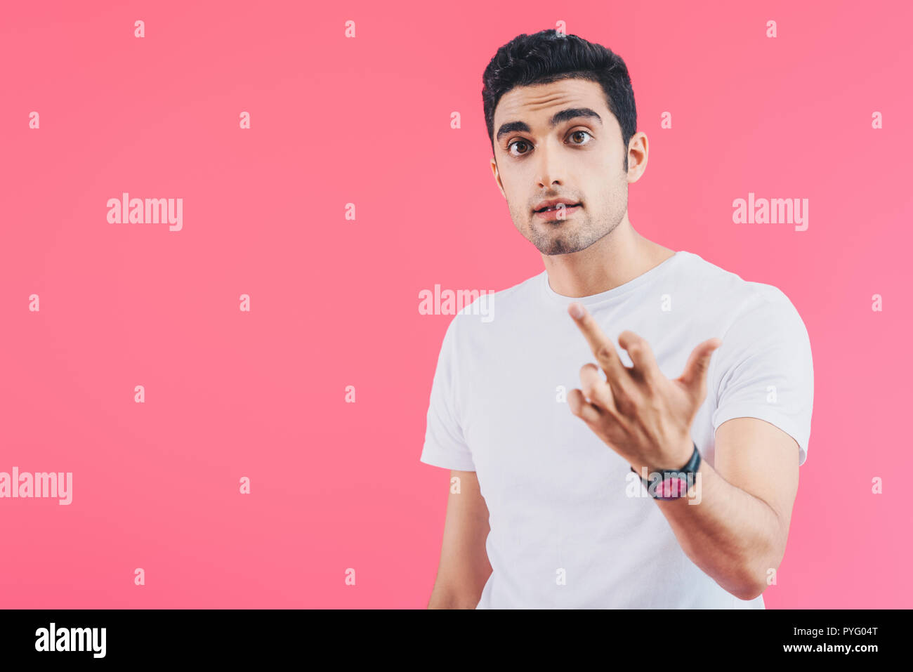 irritated man showing middle finger isolated on pink Stock Photo - Alamy