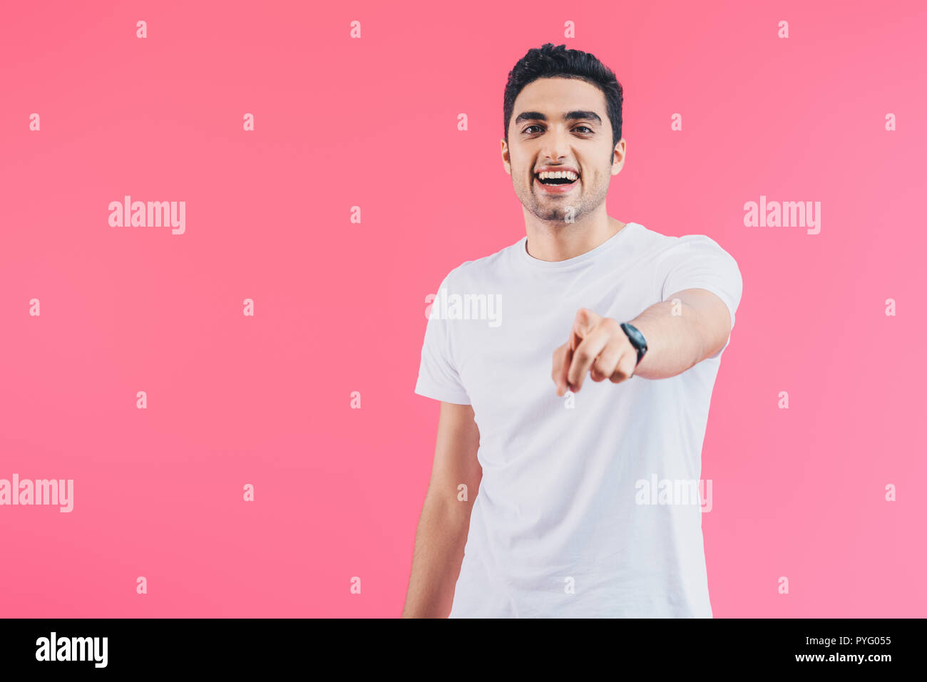 laughing man pointing on camera isolated on pink Stock Photo - Alamy