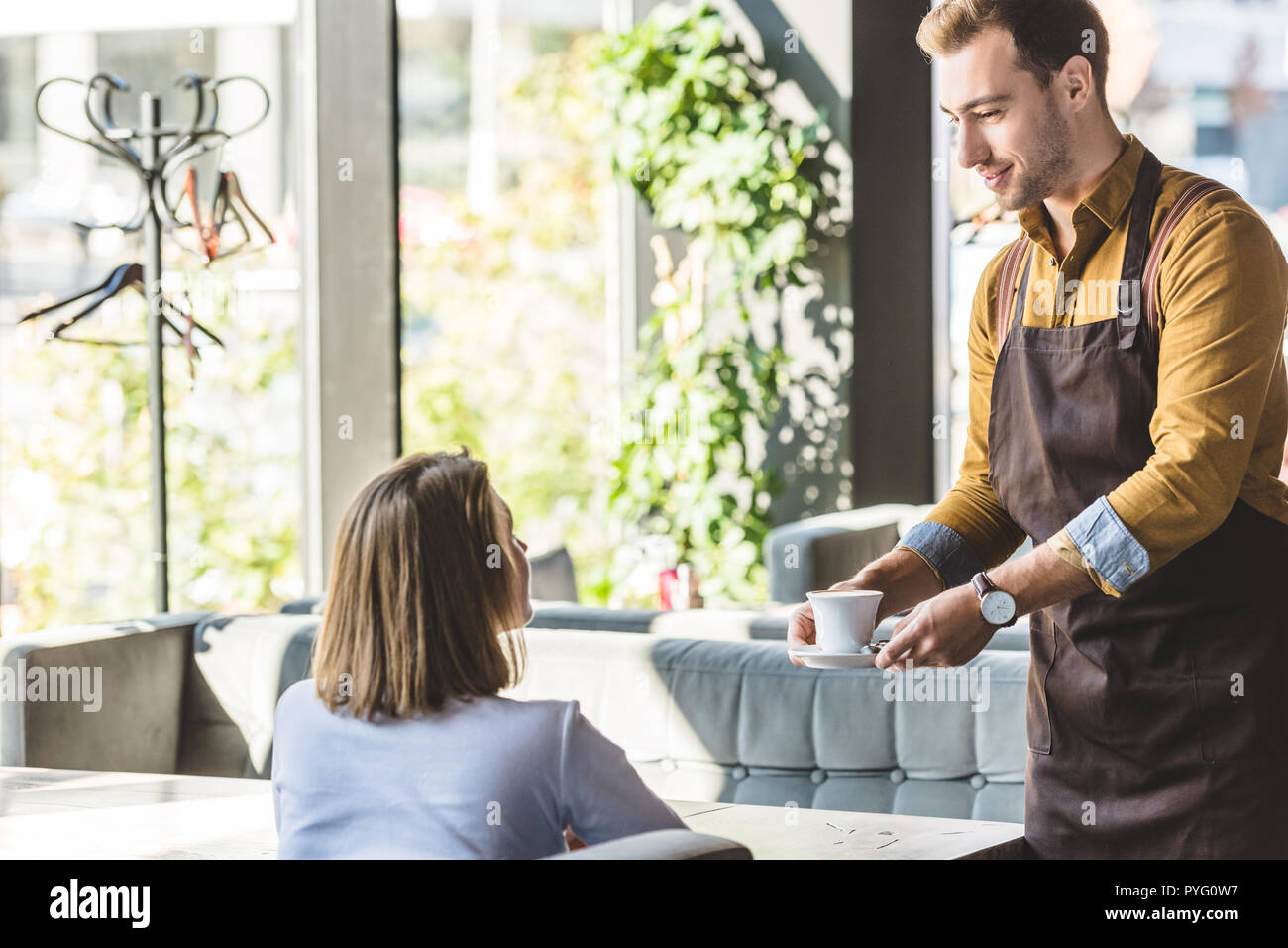 Happy female barista client hi-res stock photography and images - Alamy
