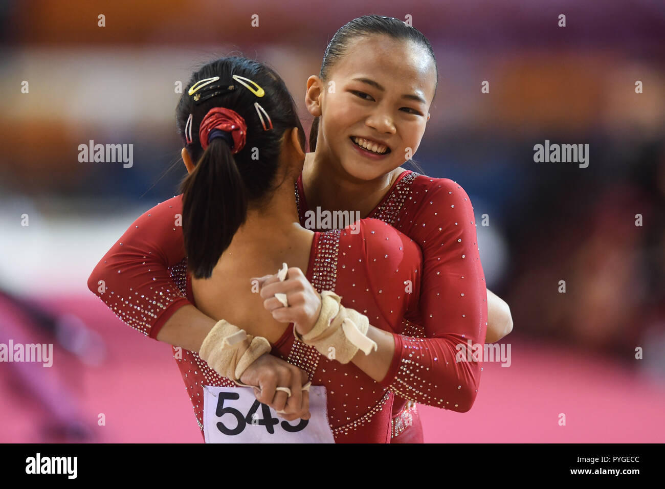 Doha, Qatar. 28th Oct, 2018. CHEN YILE hugs a teammate after finishing ...