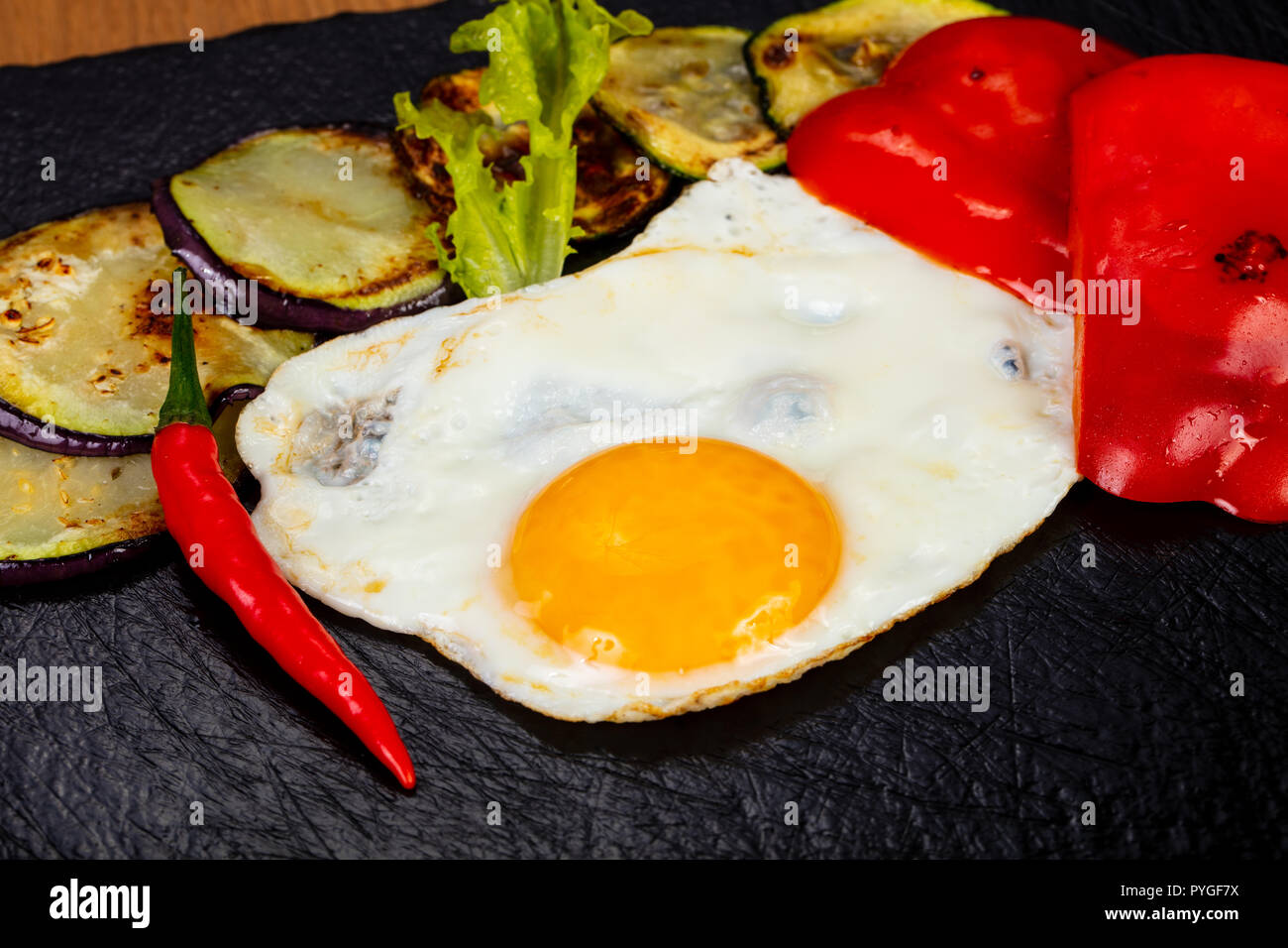 Roasted egg with grilled vegetables Stock Photo - Alamy