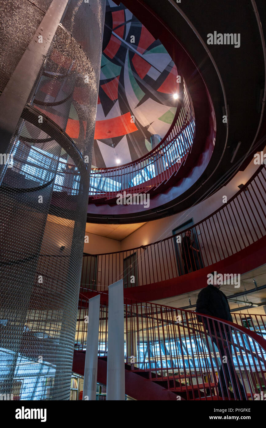 Man walking down the stairs in the The Ulm Public Library, designed by ...