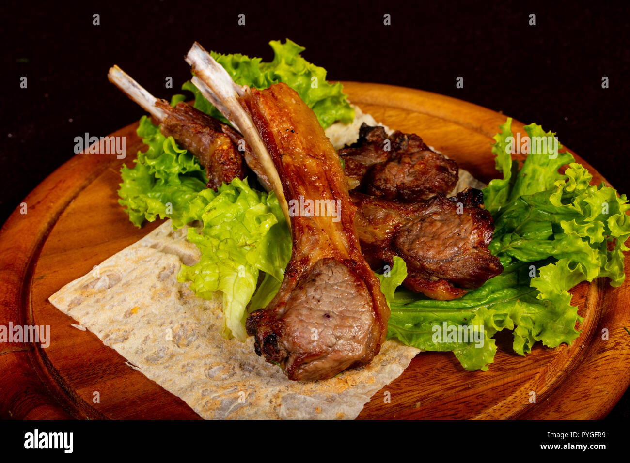 Grilled rack of lamb served salad leaves Stock Photo - Alamy