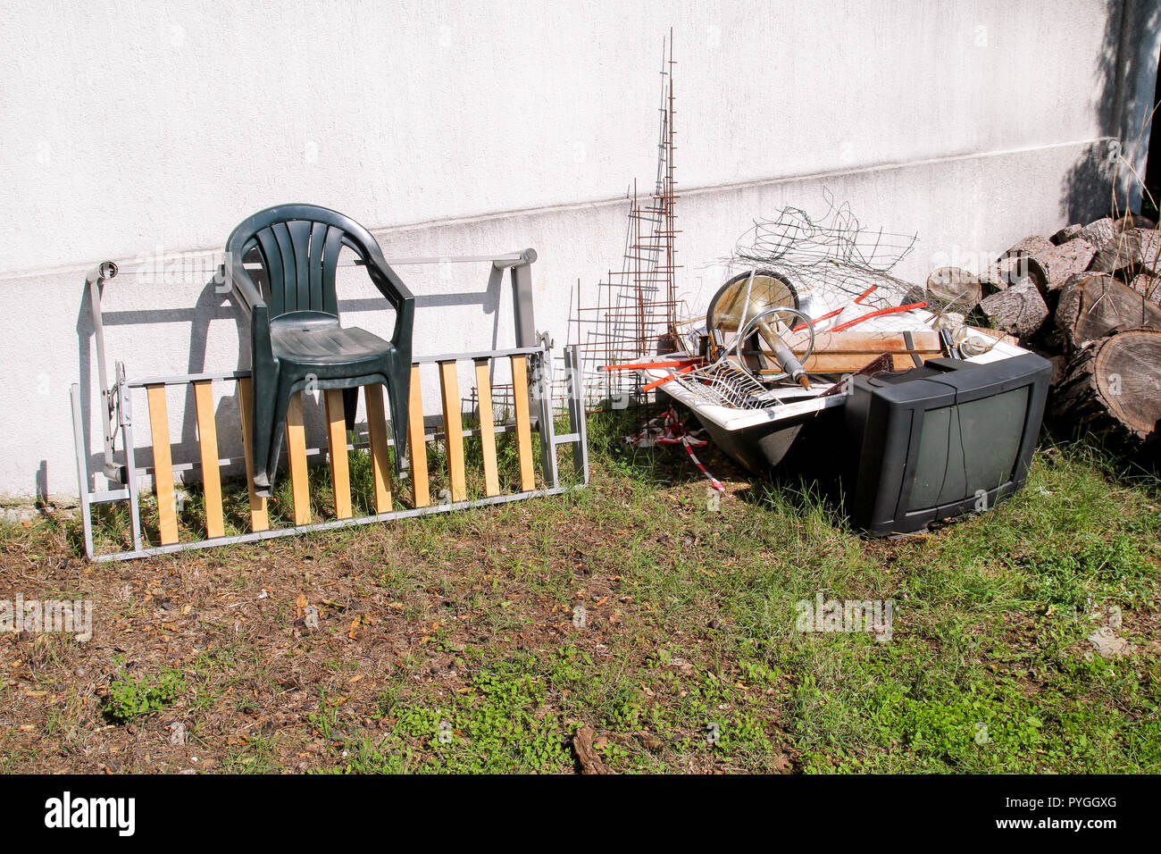 Old TV set and the rest of bulky trash. Old TV thrown away next to a ...
