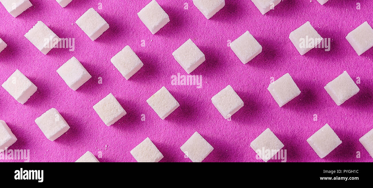 Flat lay view of food with white sugar pattern against purple ...