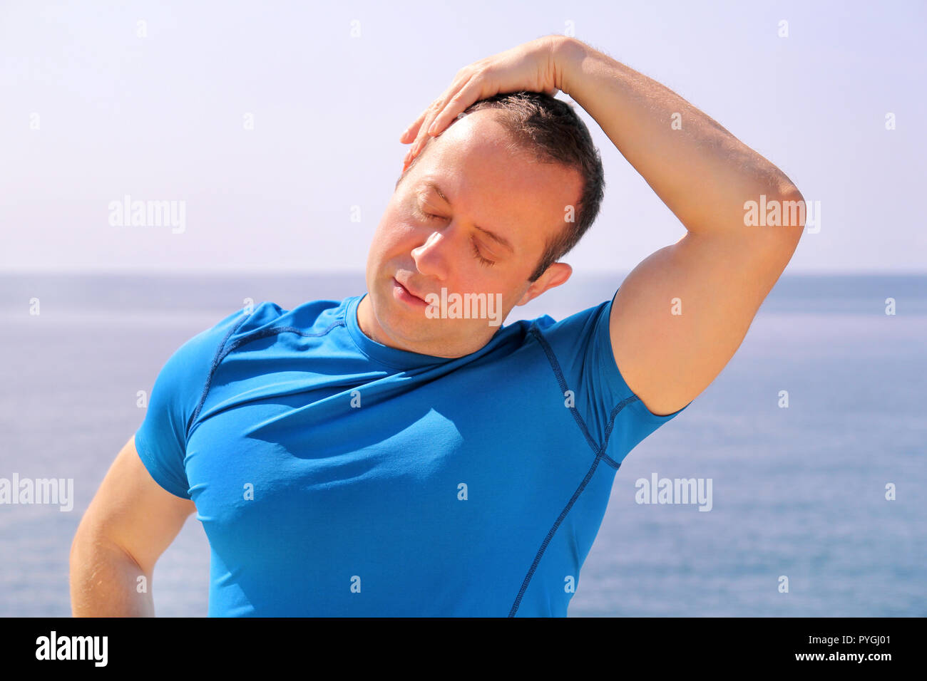 Athletic fit runner doing stretching exercise, preparing for morning ...