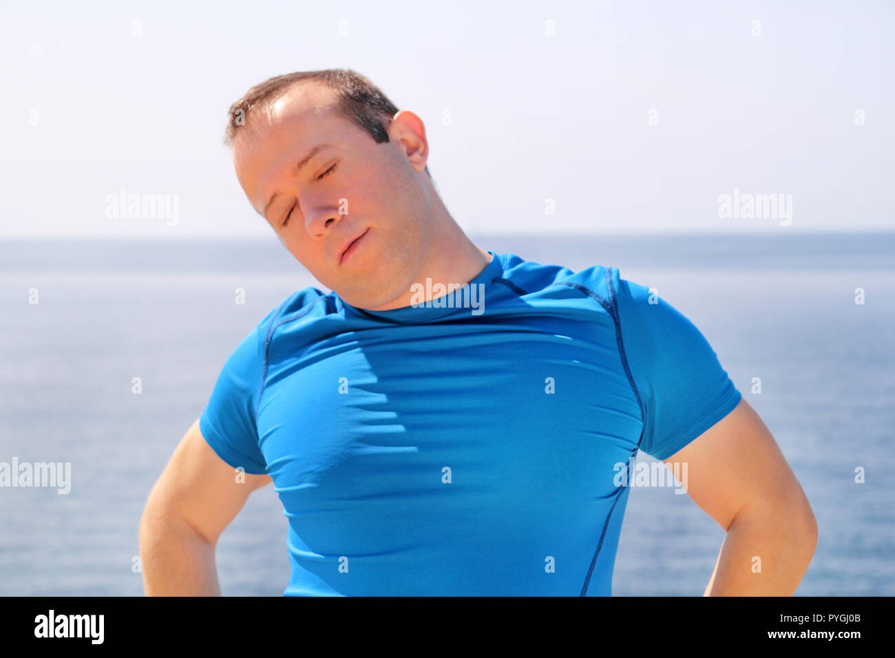 Athletic fit runner doing stretching exercise, preparing for morning ...