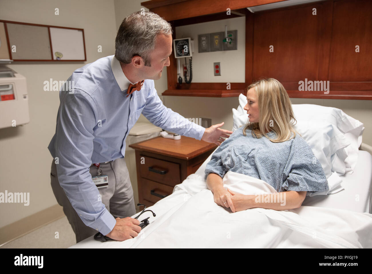 Doctor visits with patient in exam room Stock Photo - Alamy