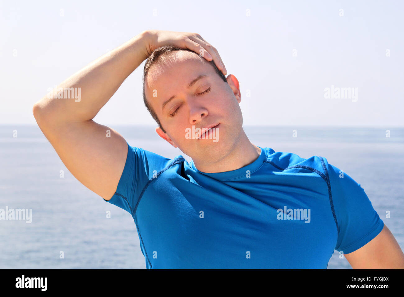 Athletic fit runner doing stretching exercise, preparing for morning ...