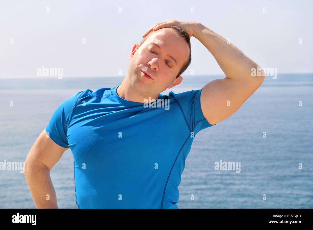 Athletic fit runner doing stretching exercise, preparing for morning ...