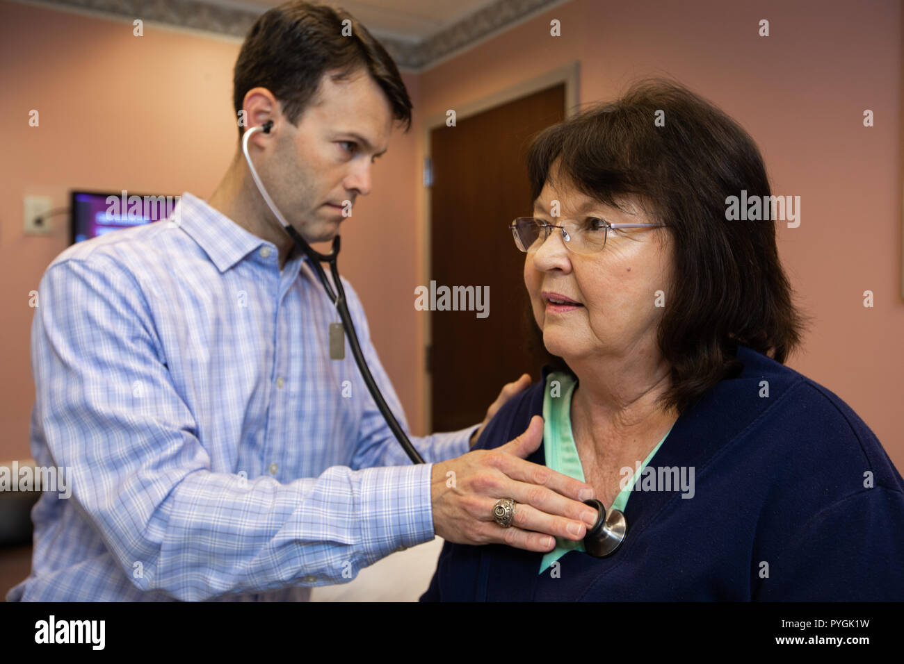 Doctor examines a hi-res stock photography and images - Alamy