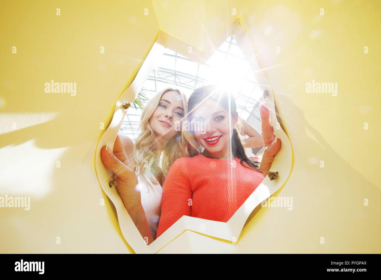 beautiful young women looking inside bag Stock Photo - Alamy