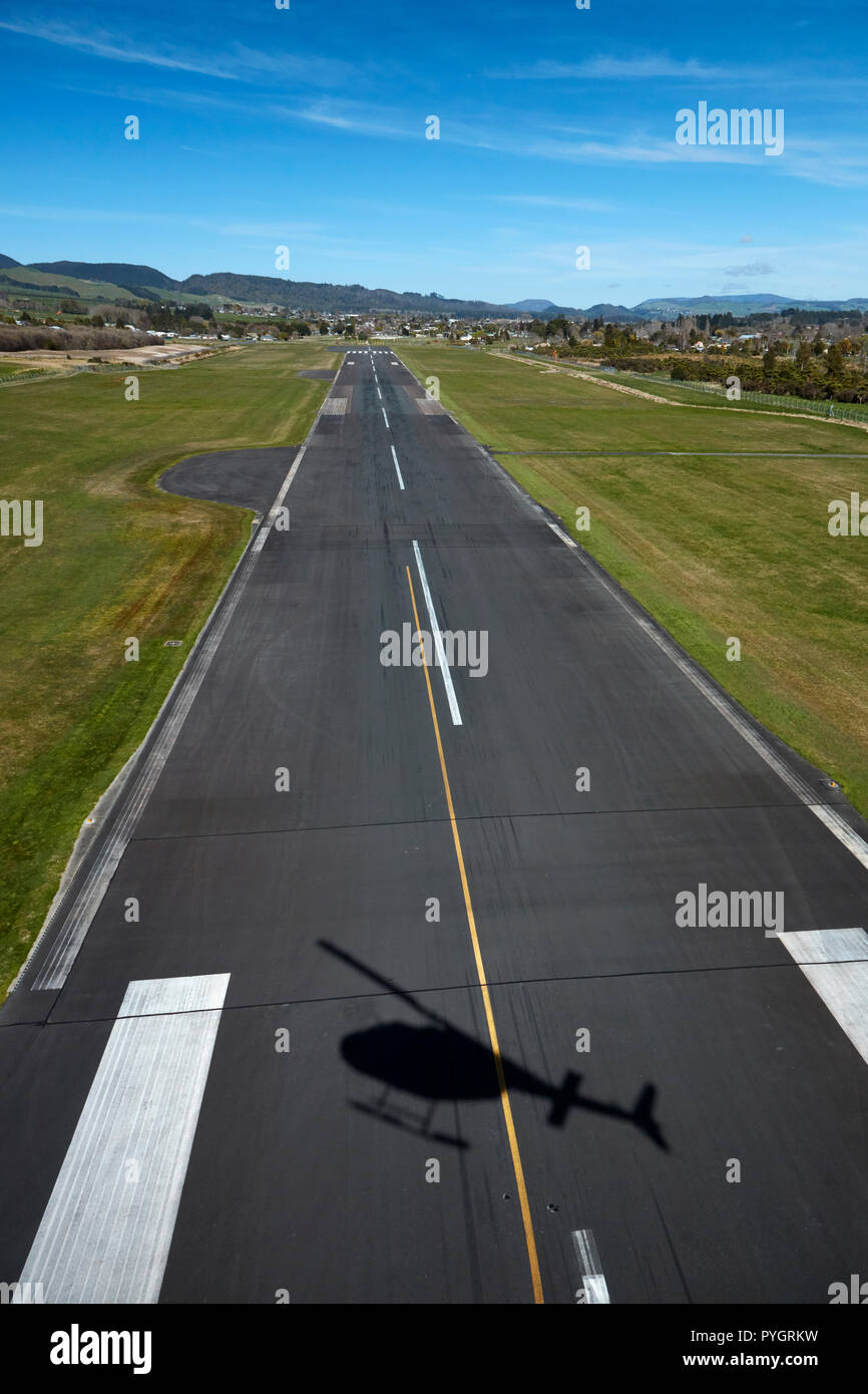 Helicopter shadow on runway, Rotorua Airport, and Lake Rotorua, Rotorua ...