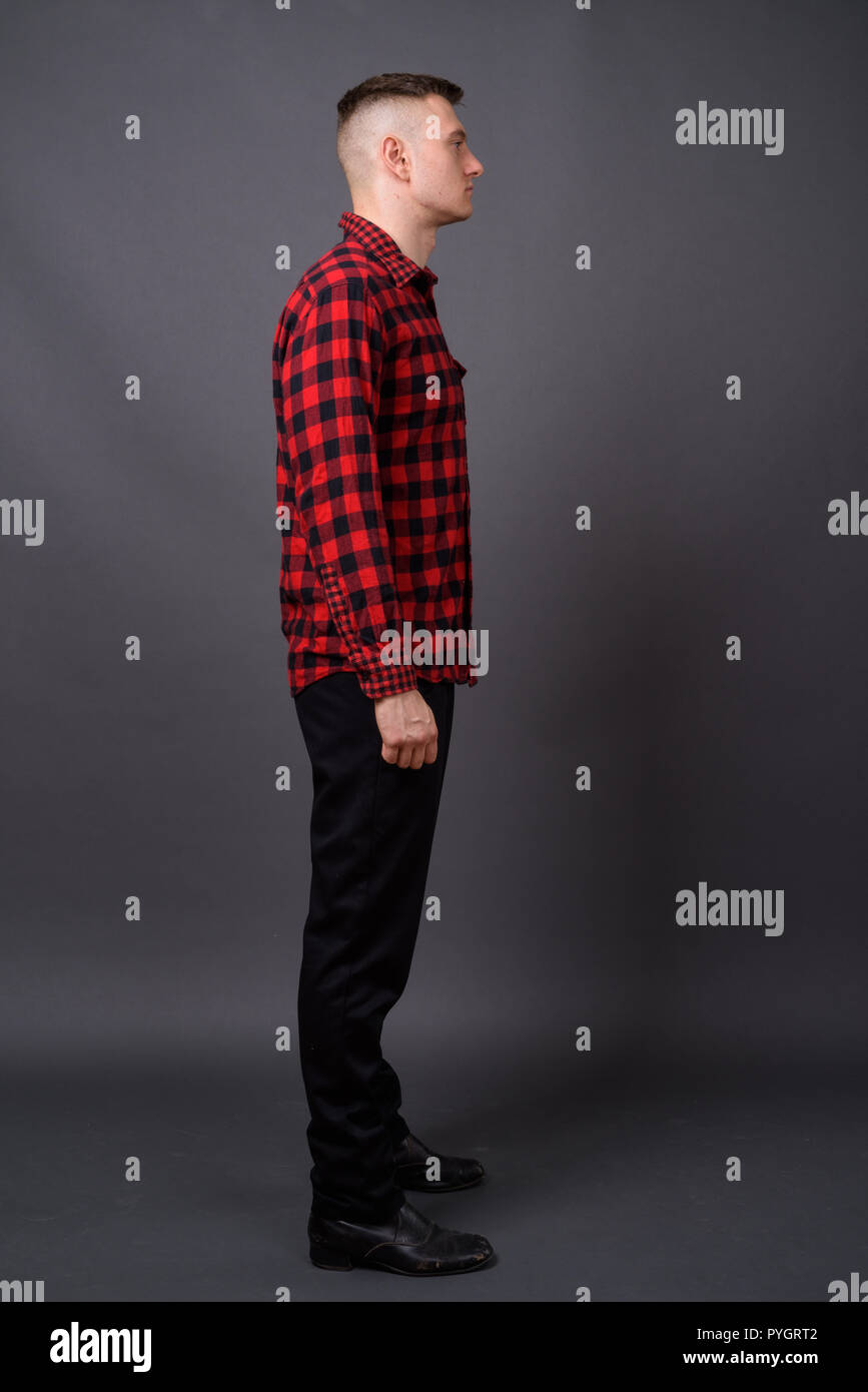 Full length profile view of young handsome man standing Stock Photo - Alamy