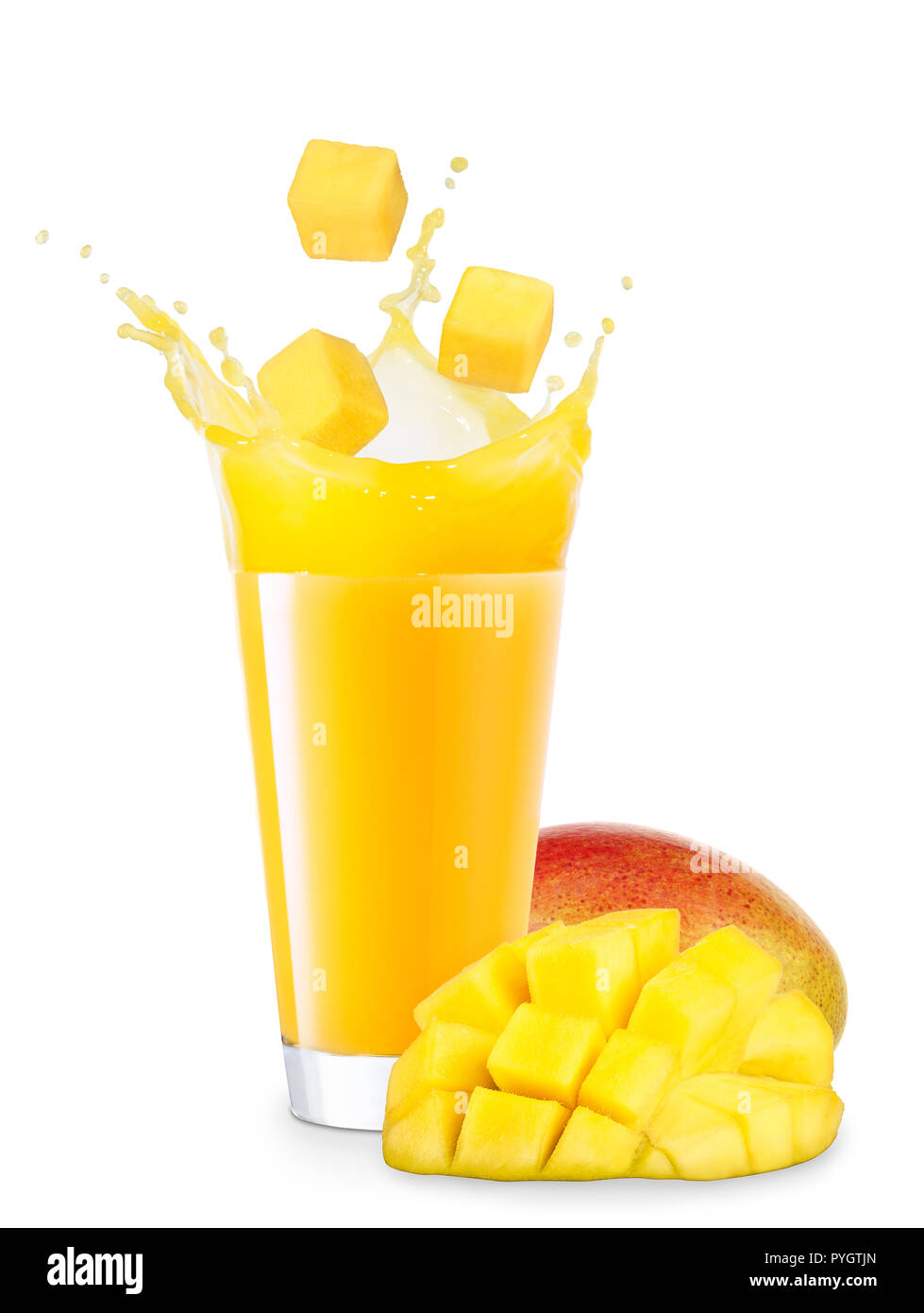 mango pieces falling into glass with juice and creating splashes ...