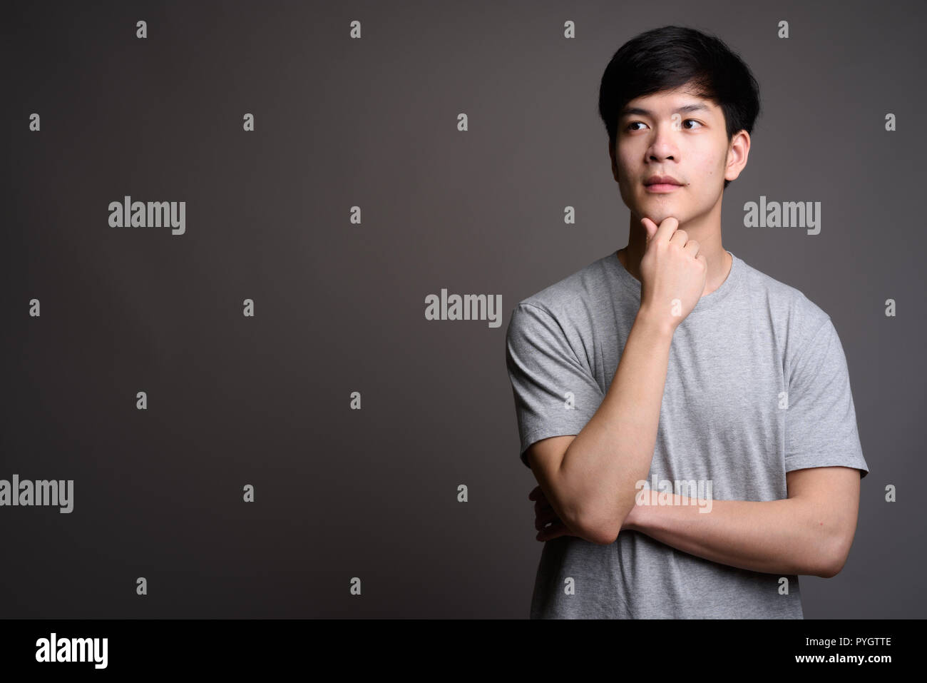 Young man thinking asian hi-res stock photography and images - Alamy