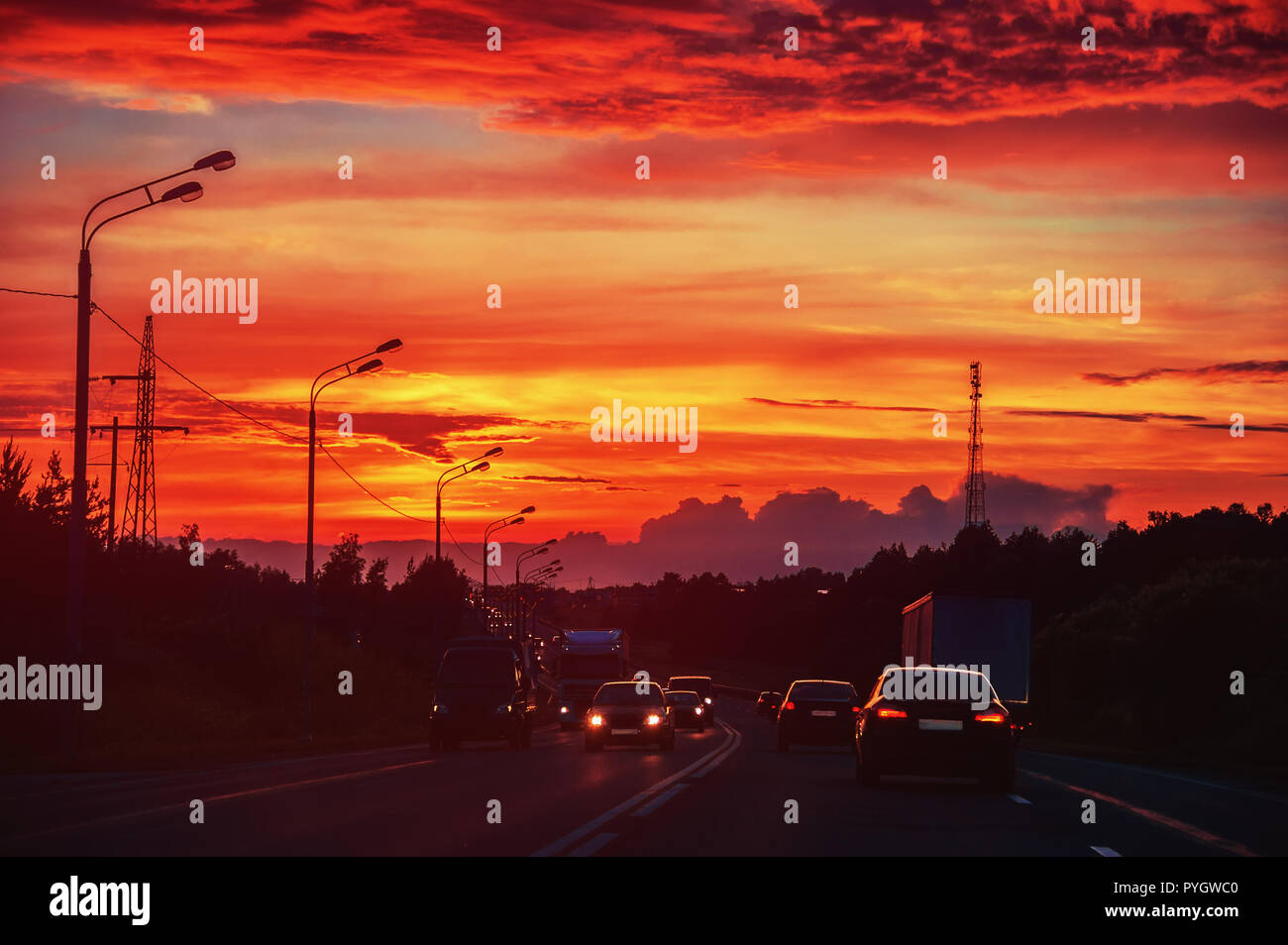 Cars ride at sunset on the road in the summer Stock Photo - Alamy