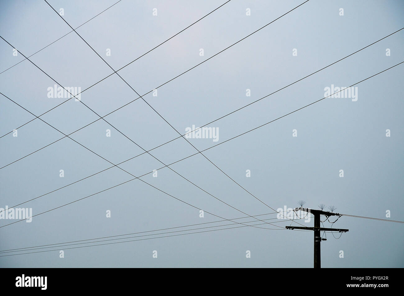 steel cables of overhead electric power line crossing in sky and ...