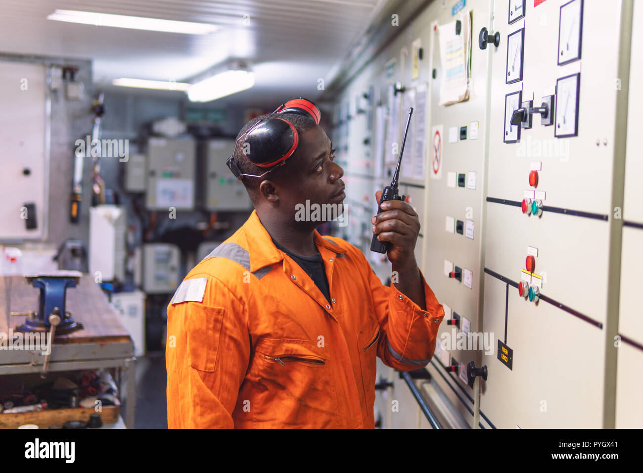 Marine engineer officer working in engine room Stock Photo - Alamy