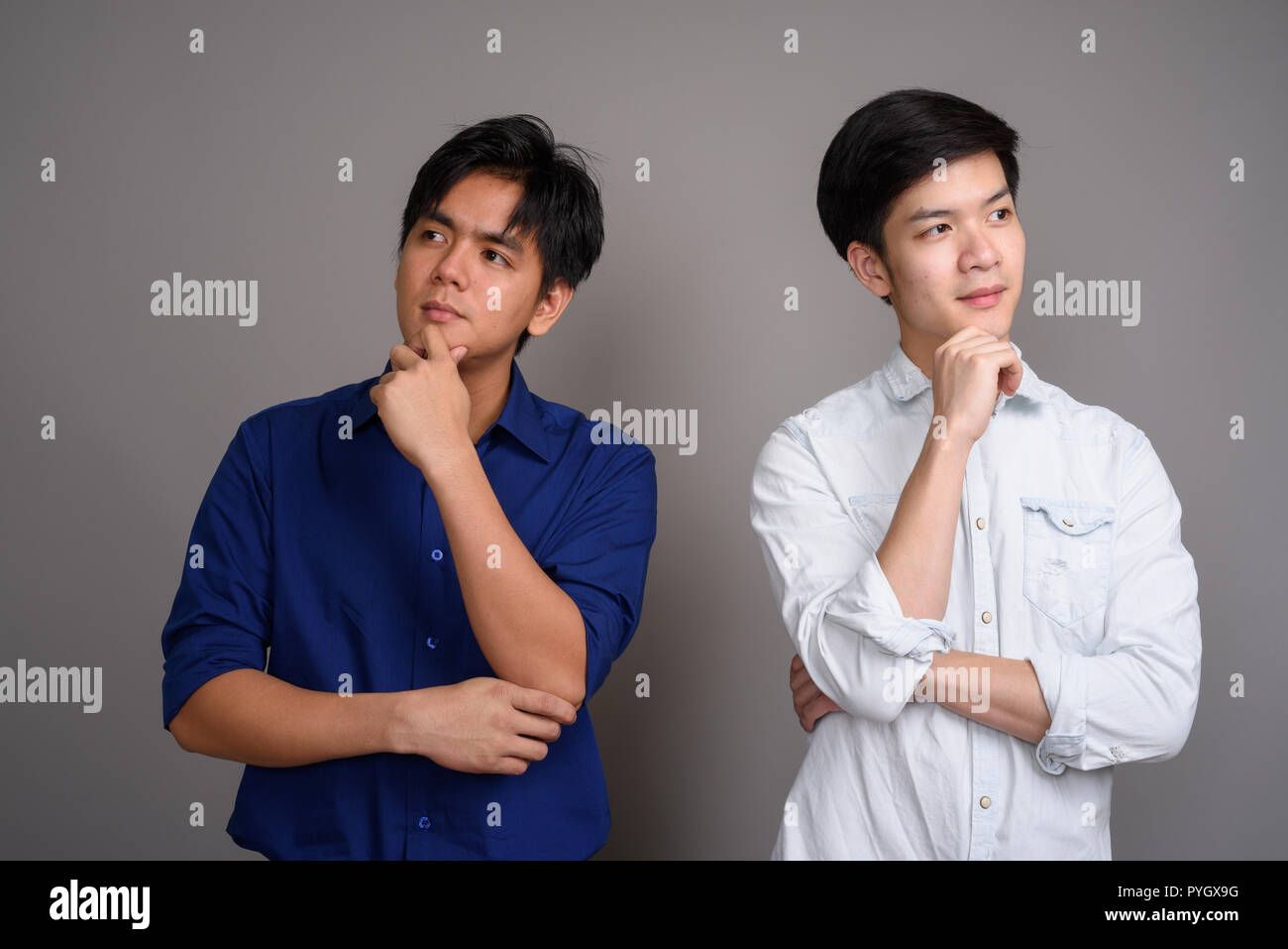 Two young man thinking and looking up Stock Photo - Alamy