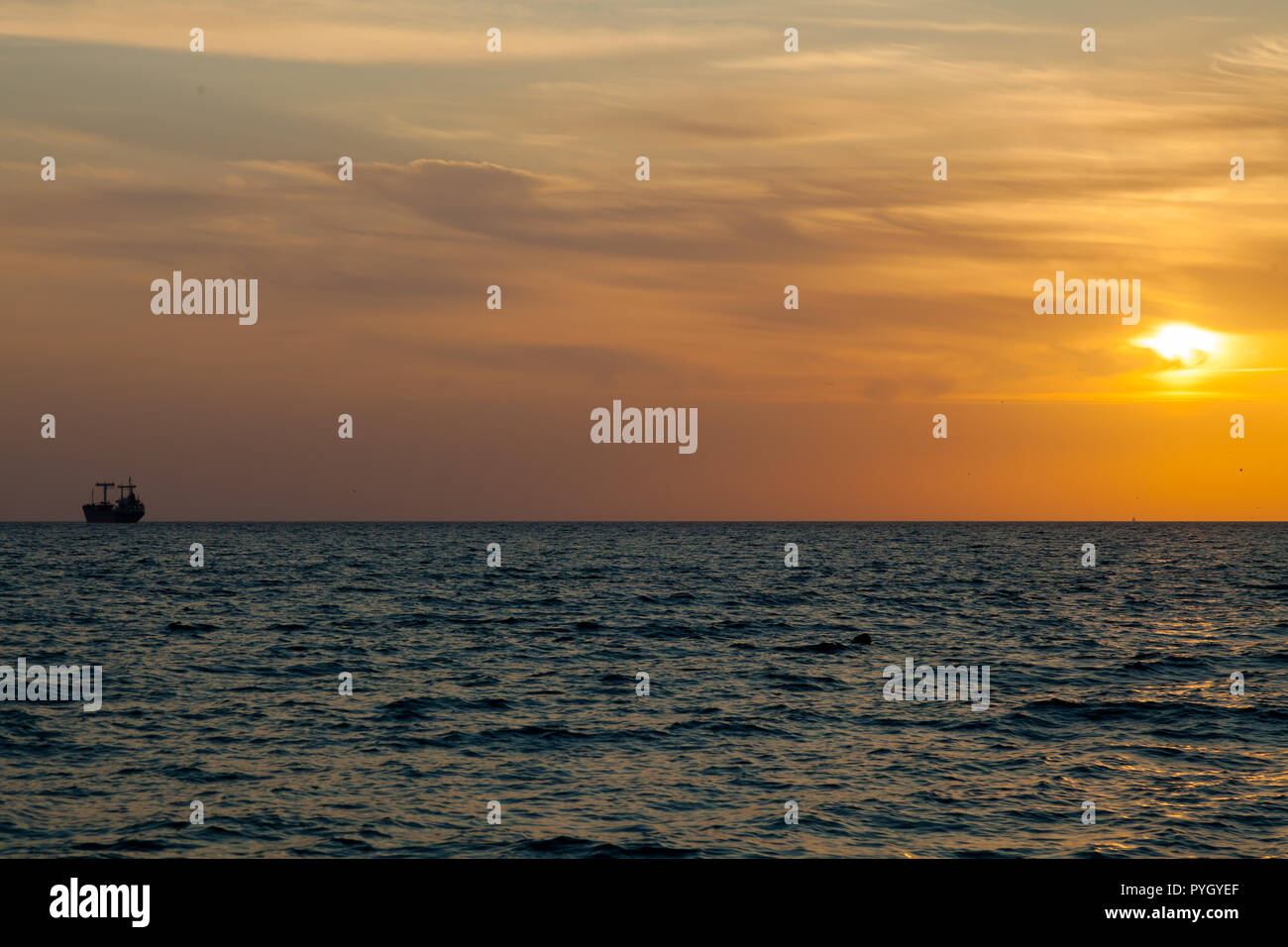 Sunset landscape ocean sea and ship on the horizon Stock Photo - Alamy