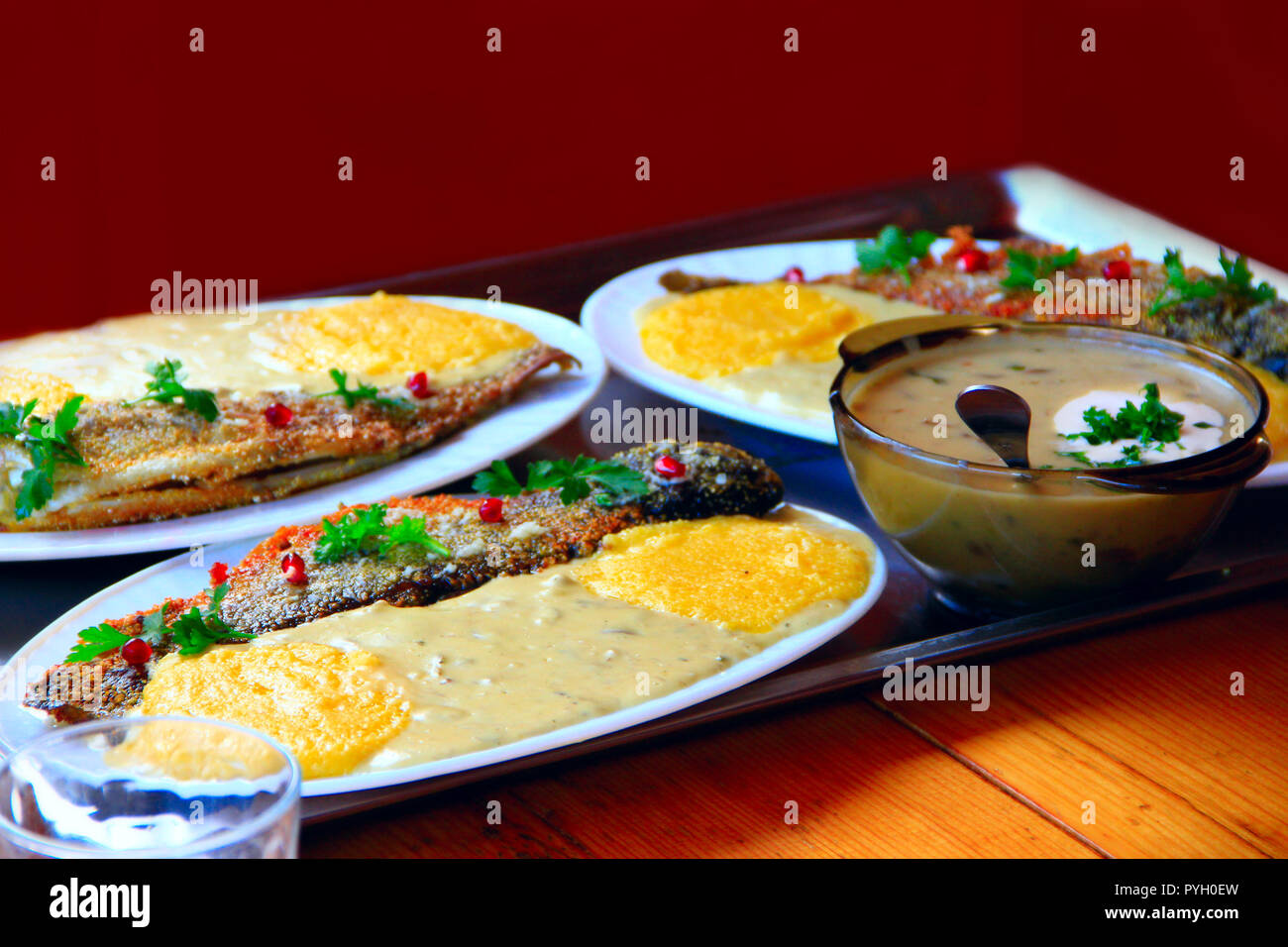 Trout fried with banusz. Dish with fried trout and banusz with mushroom ...