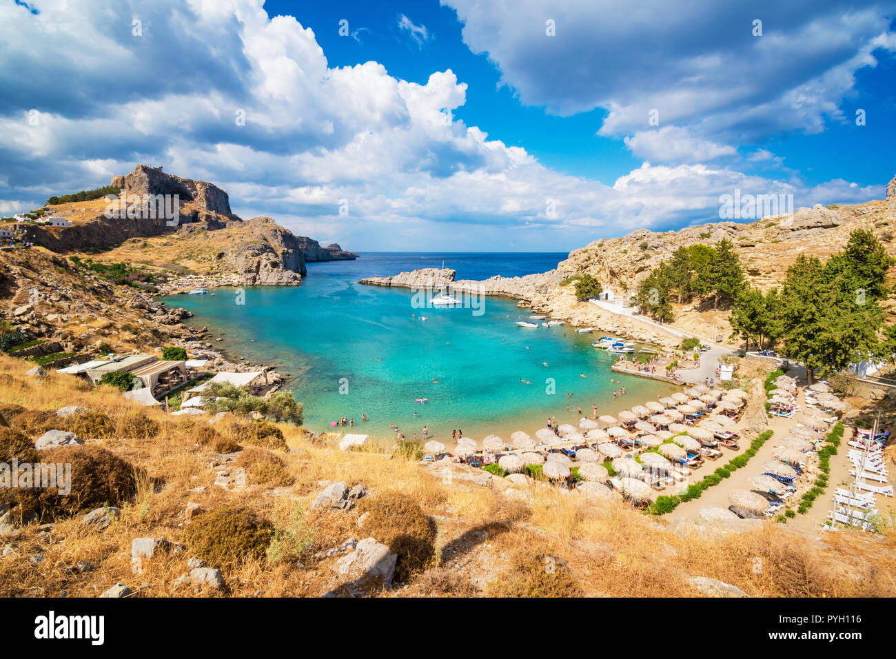St. Paul bay with boats, Lindos acropolis in background (Rhodes, Greece ...