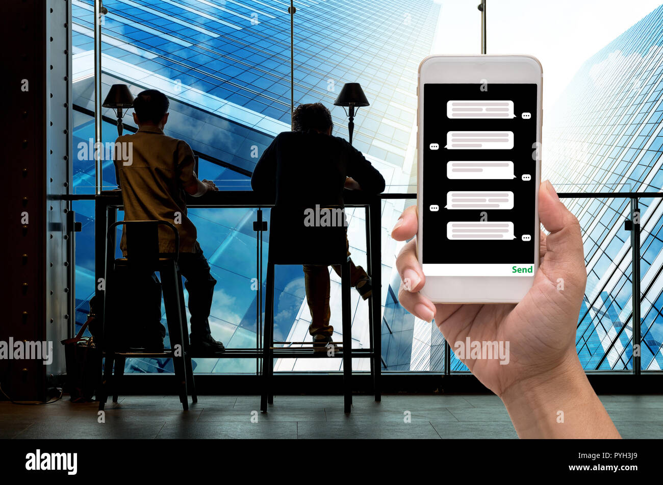 Female hand holding mobile phone showing the chat message before place ...