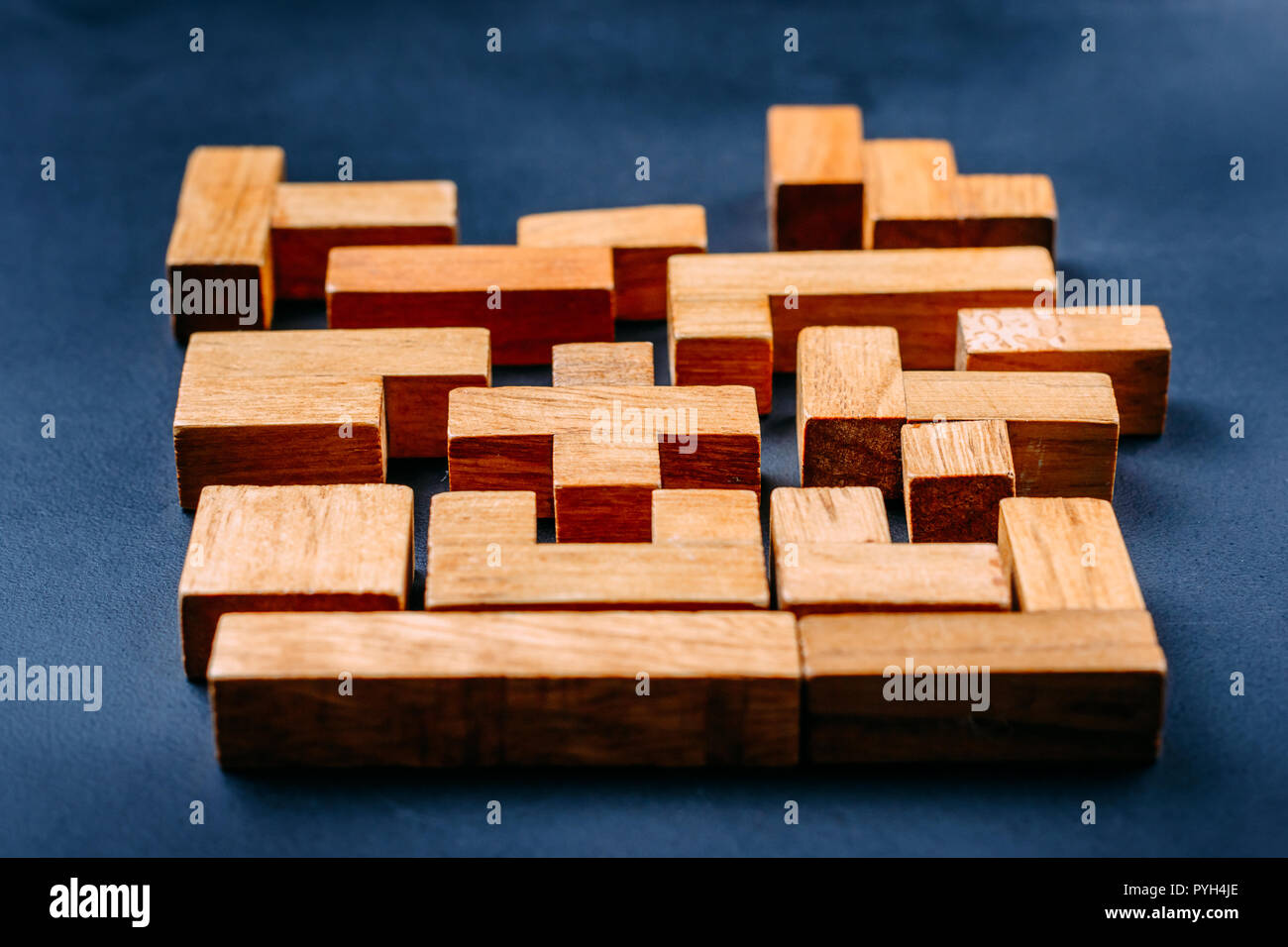 Different geometric shapes wooden blocks on dark background. Creative ...