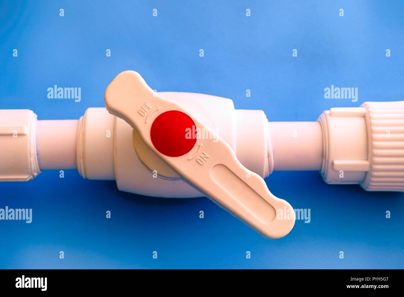 Pipe with red switch on blue background. Close-up Stock Photo - Alamy