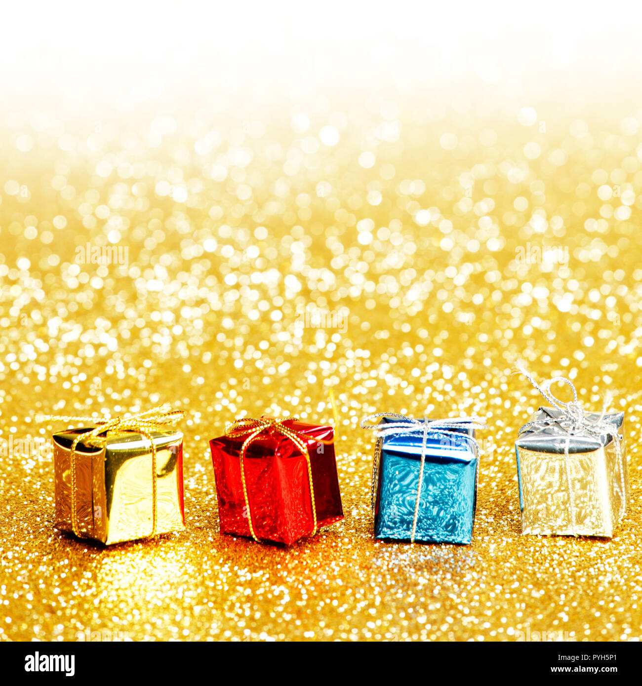 Small decorative colorful presents on glitter background Stock Photo ...