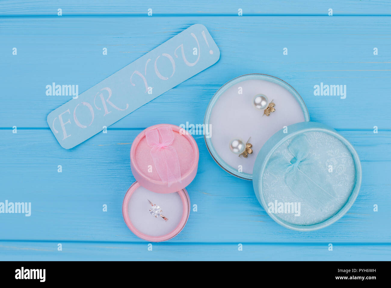 Round containers for ring and earrings and for you note. Top view. Blue ...
