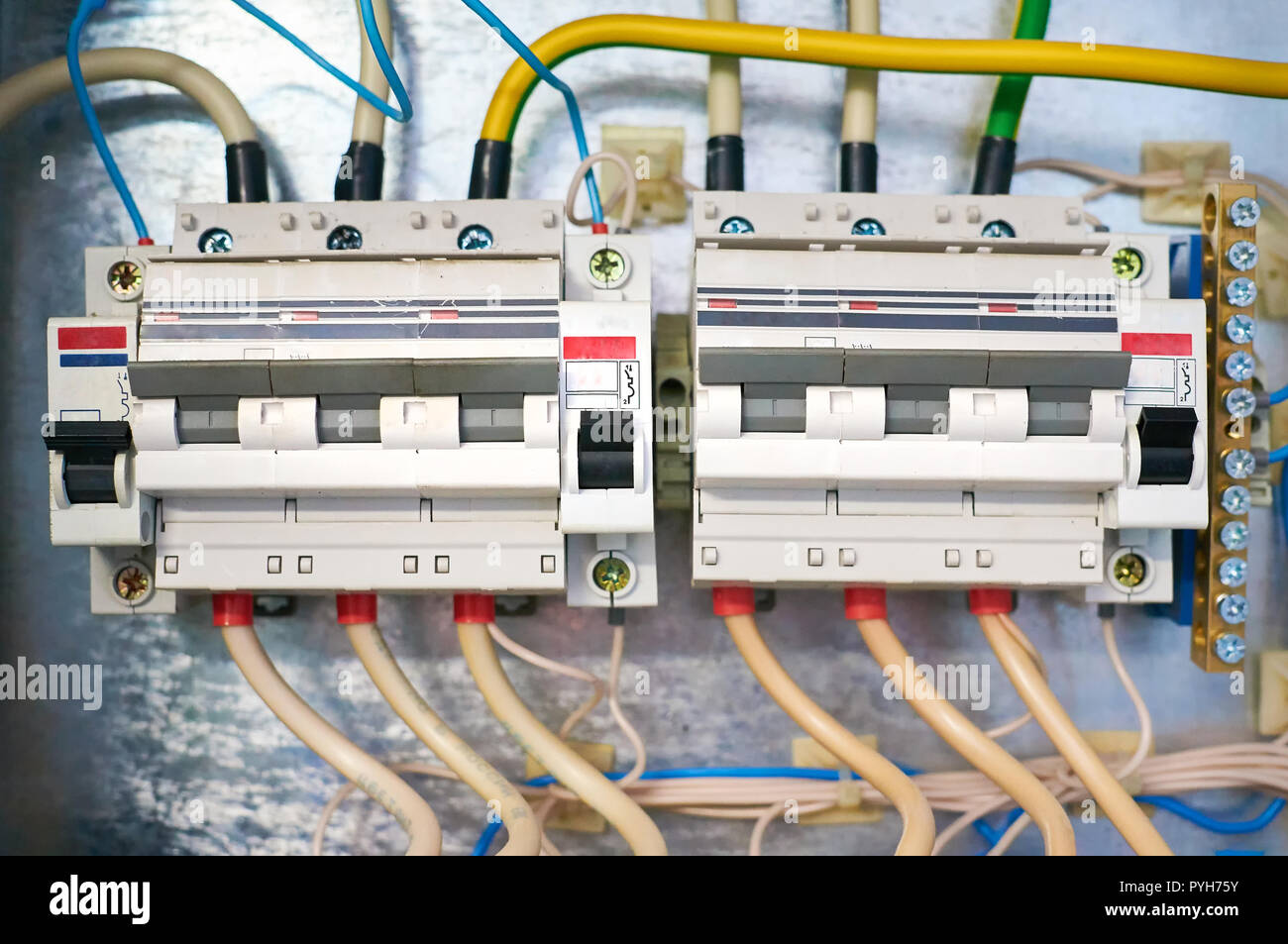 Two electric wires connected trozfaznyh switch on metal background ...