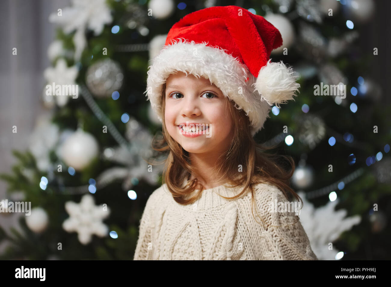 funny beautiful girl with red santa hat Stock Photo - Alamy