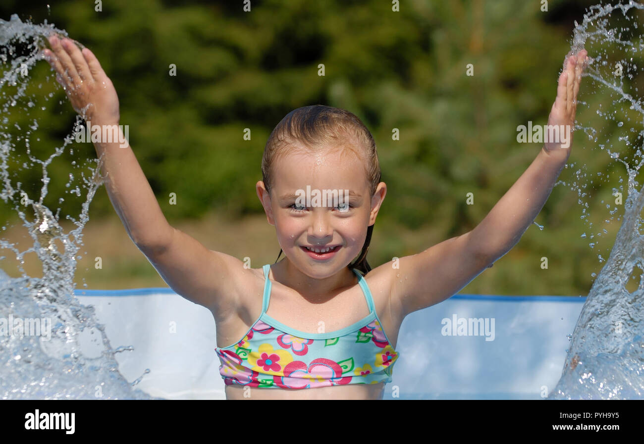 Little girl playing in the water hi-res stock photography and images ...