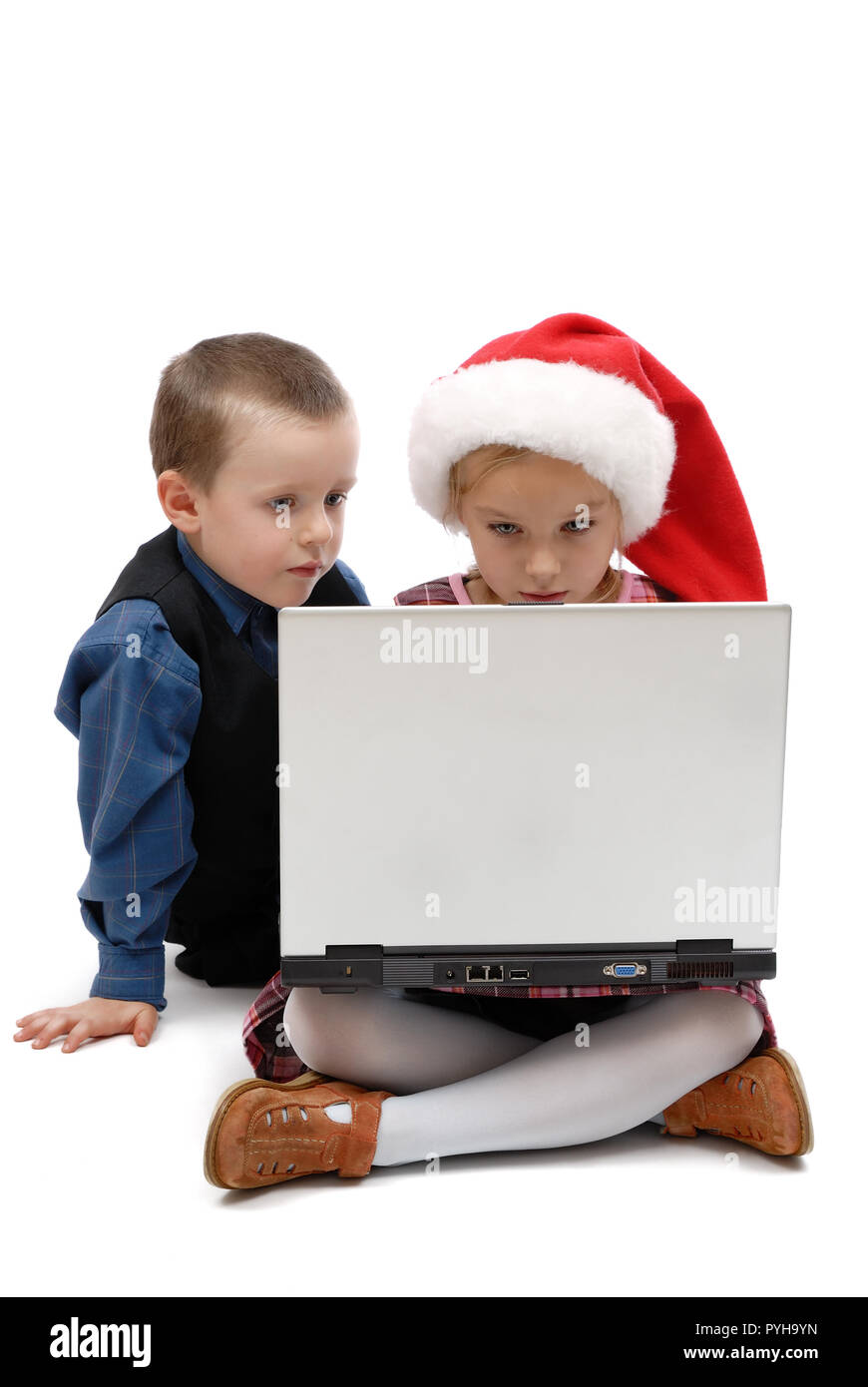 Girl and boy playing on a laptop on white background, isolated Stock ...