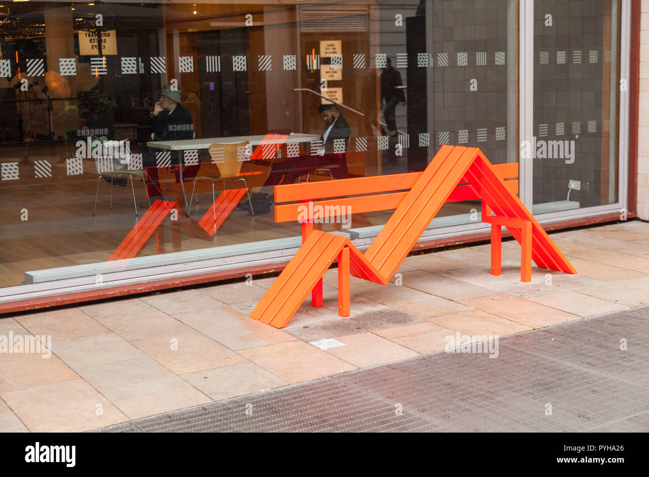 An orange bench,art installation by Danish artist, Jeppe Hein, at the ...