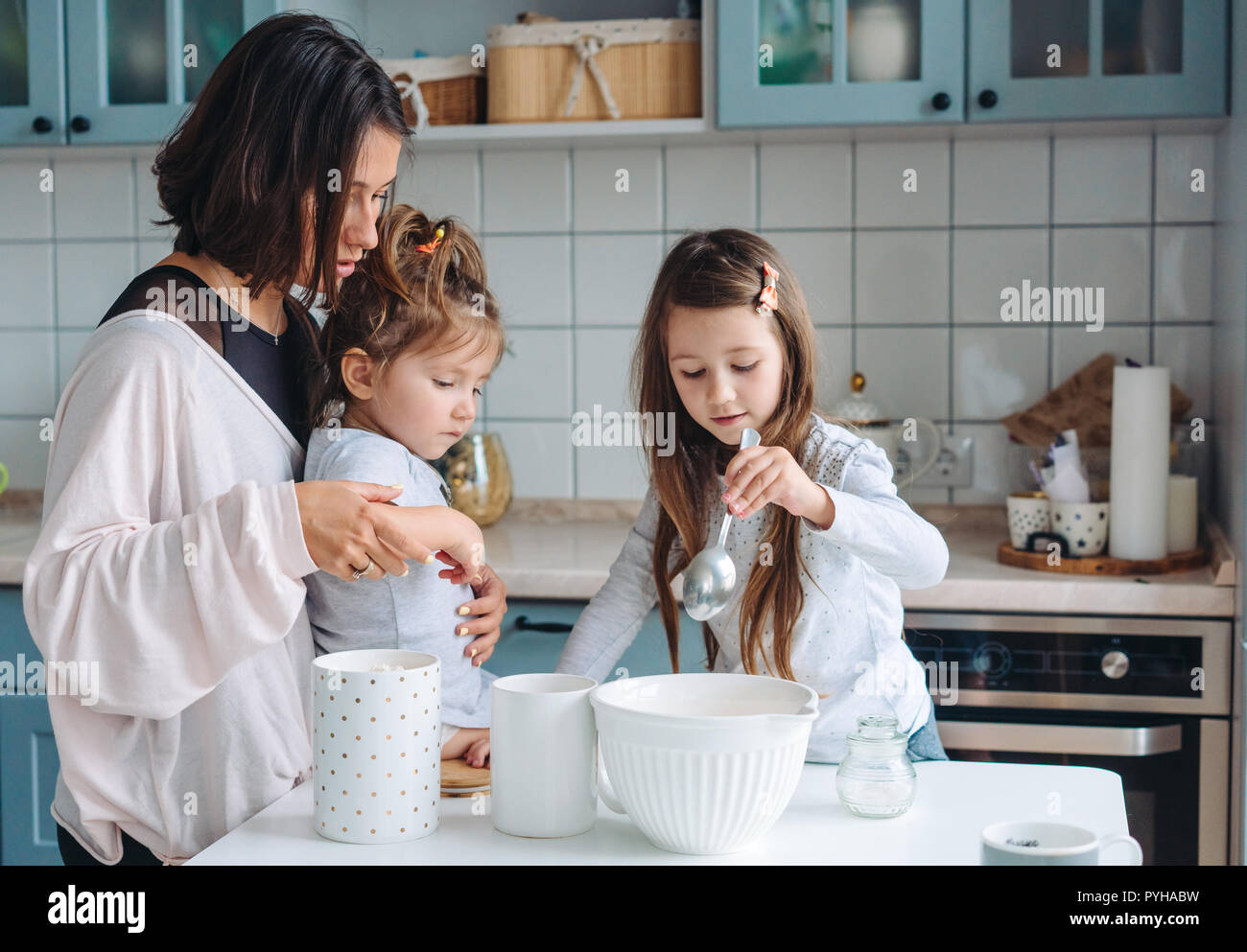 Happy family cook together in the kitchen Stock Photo - Alamy