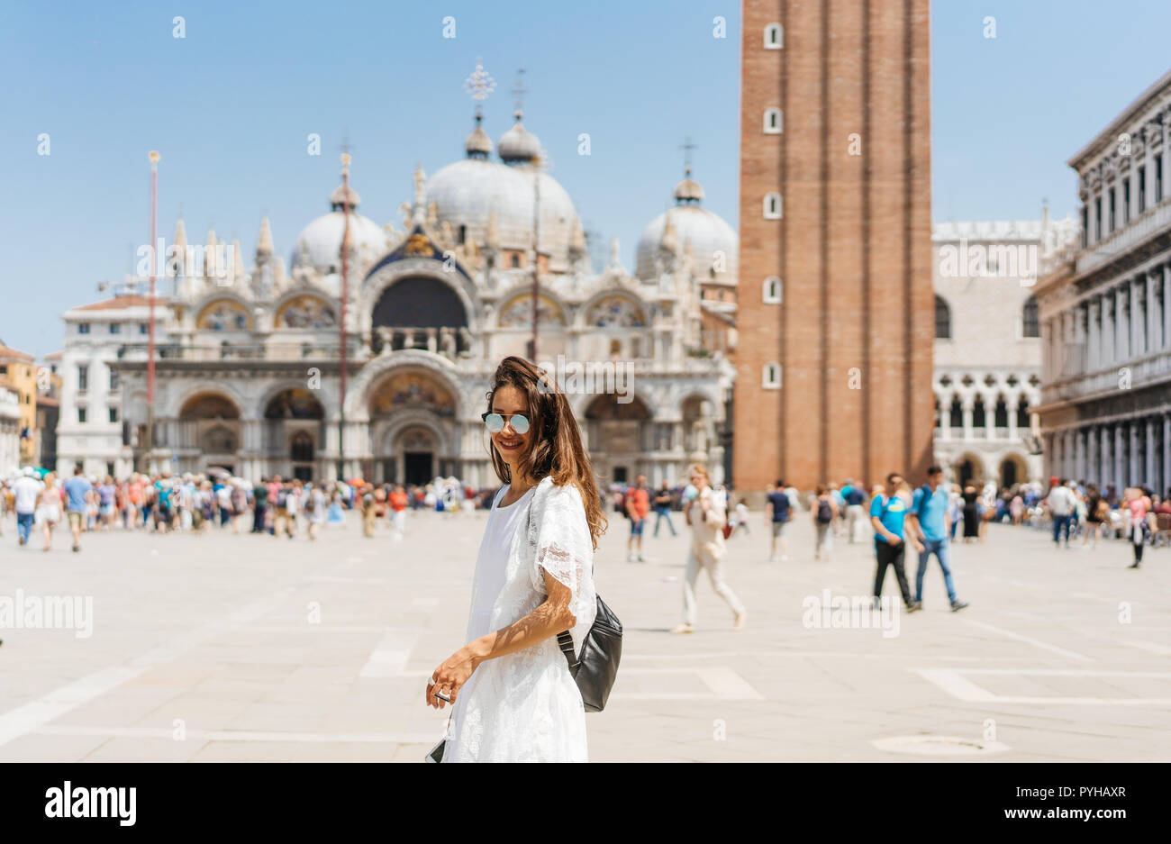 young girl is walking around the city square Stock Photo - Alamy