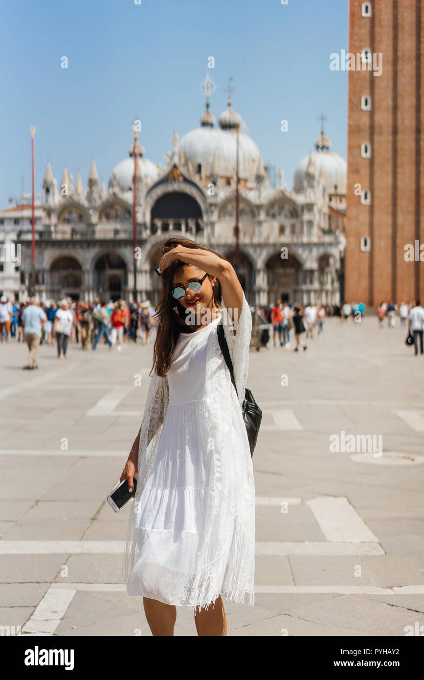 young girl is walking around the city square Stock Photo - Alamy