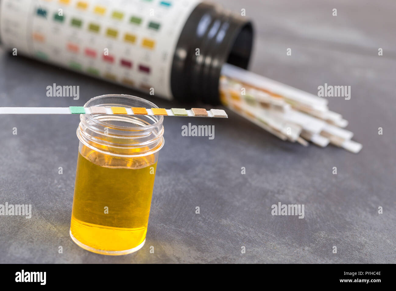 Strip of pH paper resting on specimen, with comparison chart box Stock ...
