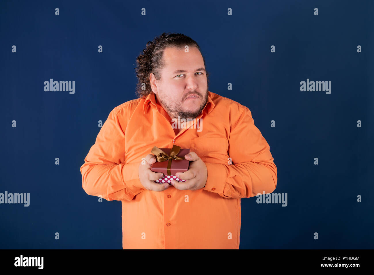Funny fat man opens a box with a gift. Birthday celebration Stock Photo ...