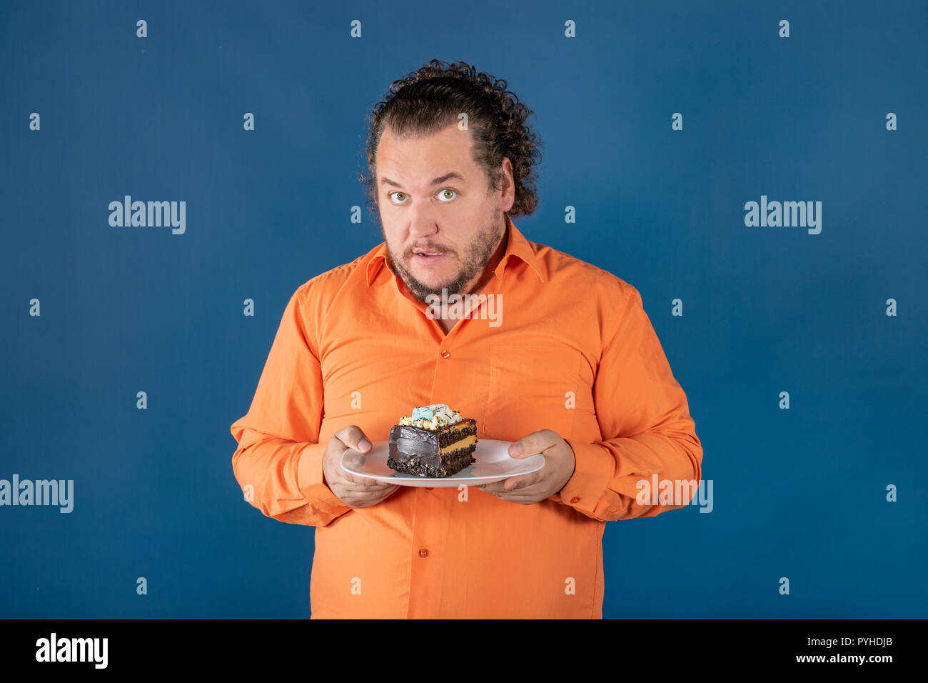 Happy fat man eating chocolate hi-res stock photography and images - Alamy