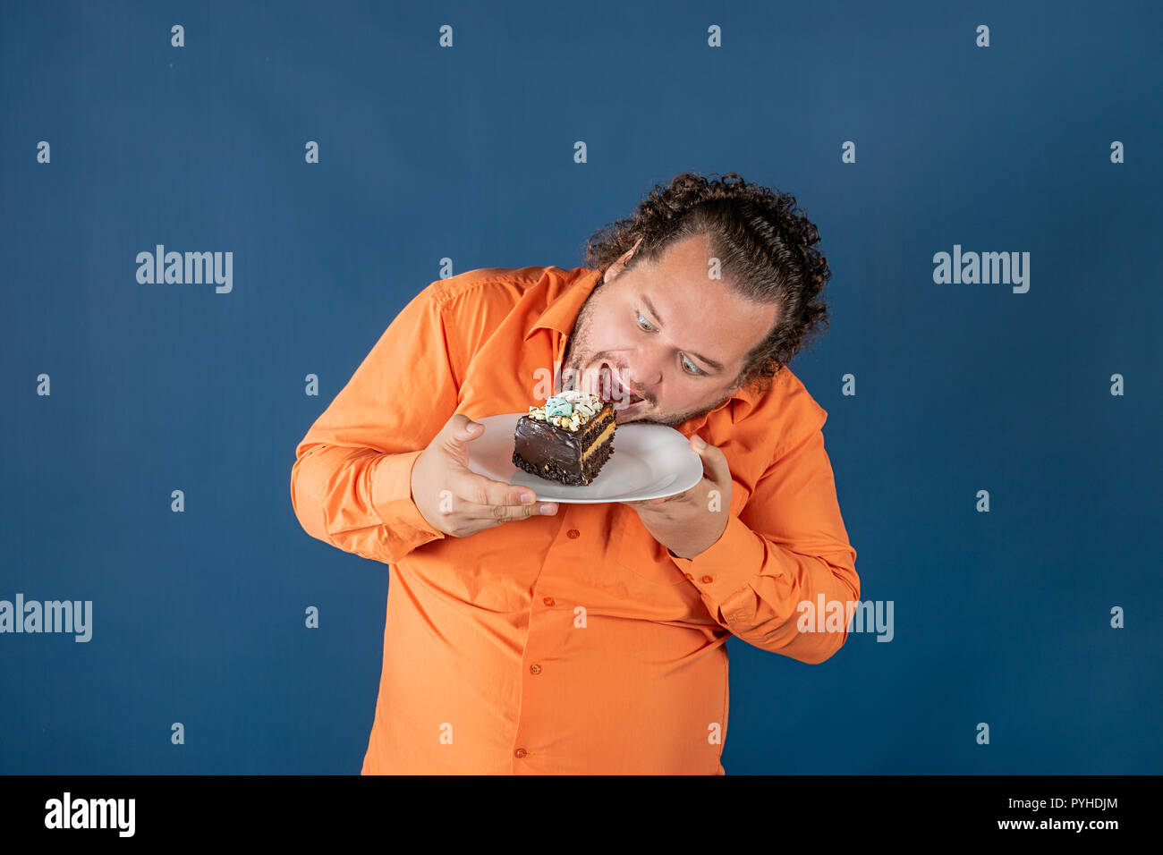 Happy fat man eating chocolate hi-res stock photography and images - Alamy