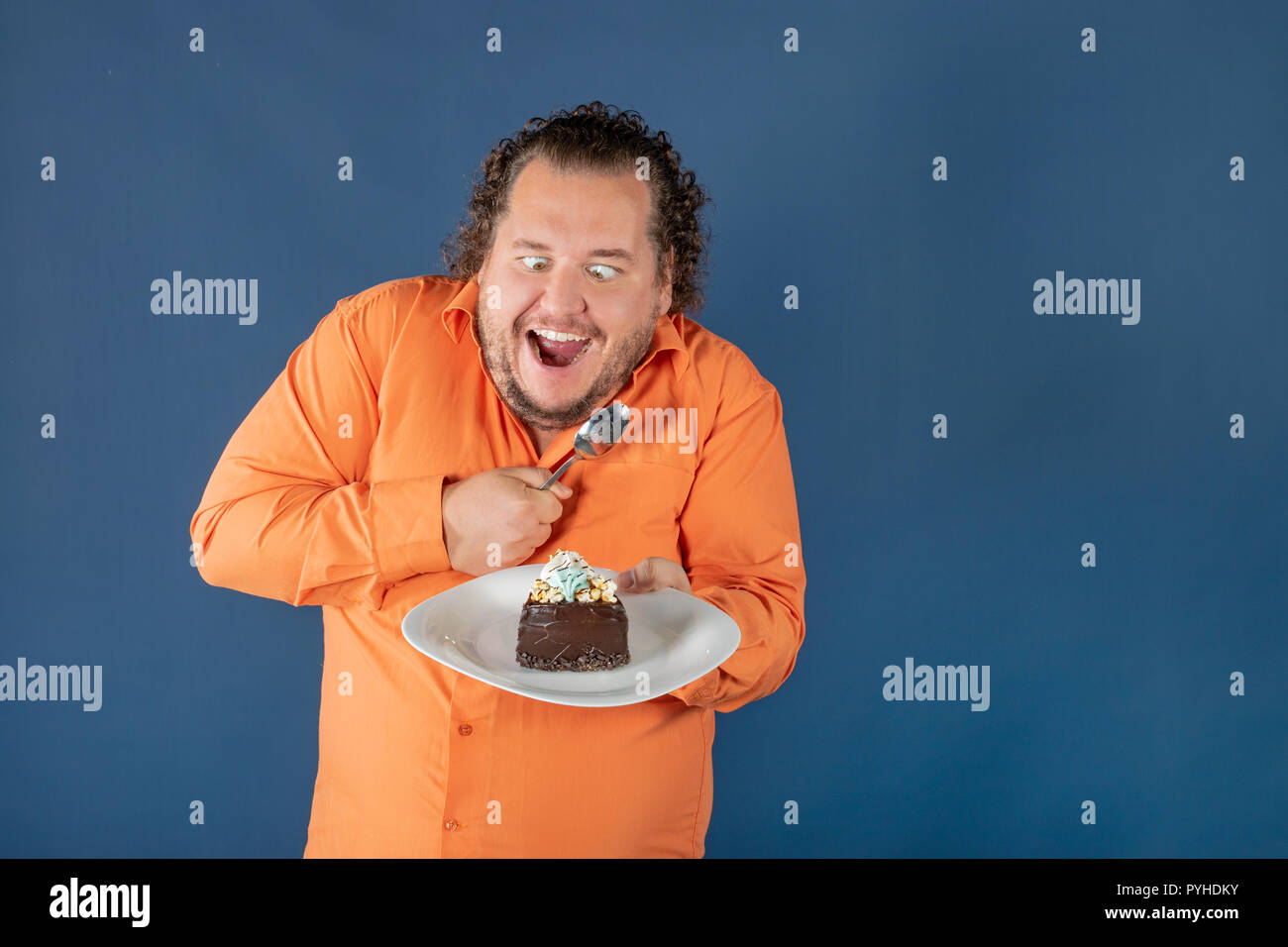 Happy fat man eating chocolate hi-res stock photography and images - Alamy