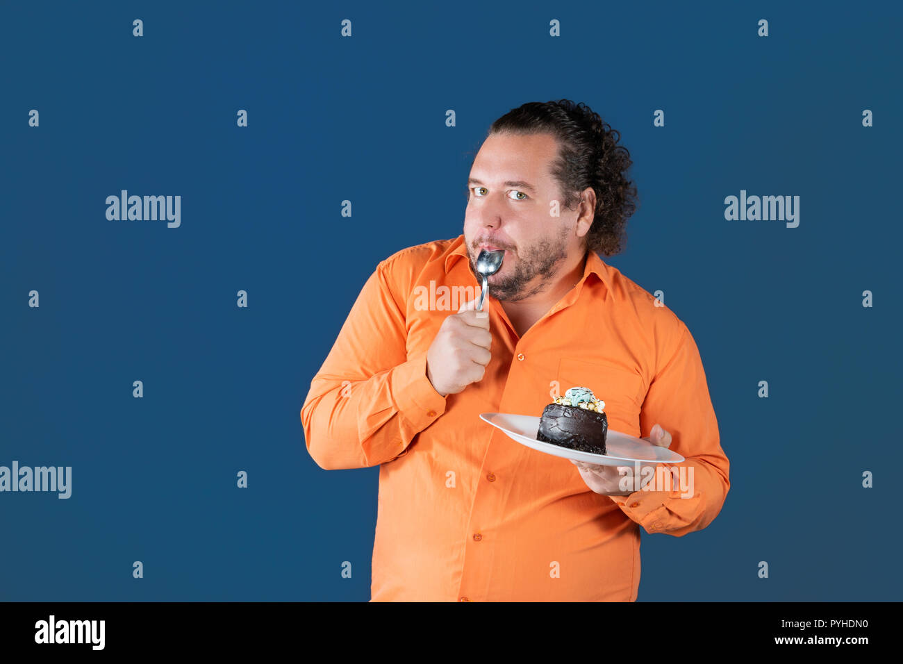 Happy fat man eating chocolate hi-res stock photography and images - Alamy