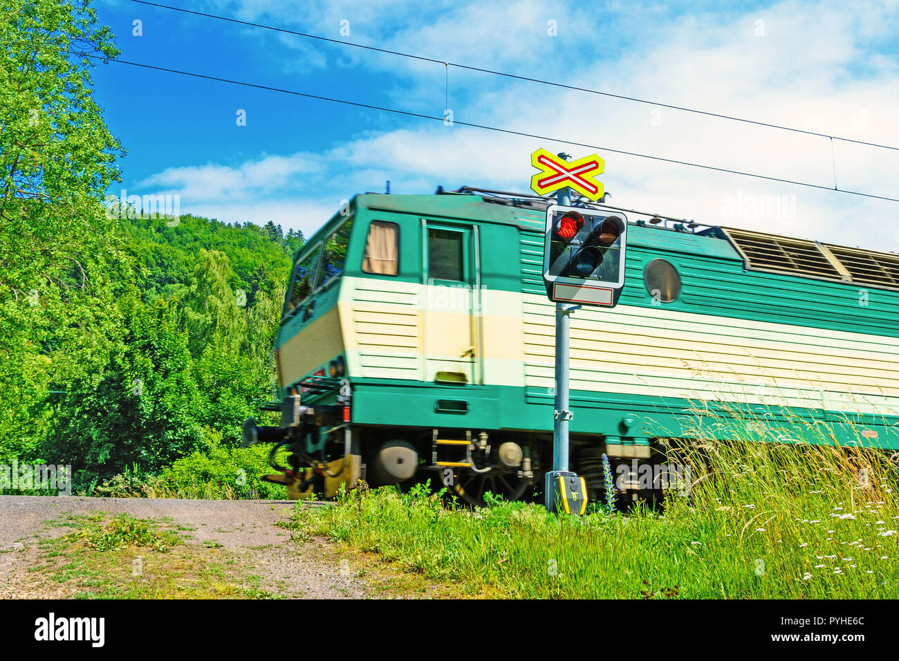 Semaphores in front of the railway crossing. A train crossing a railway ...