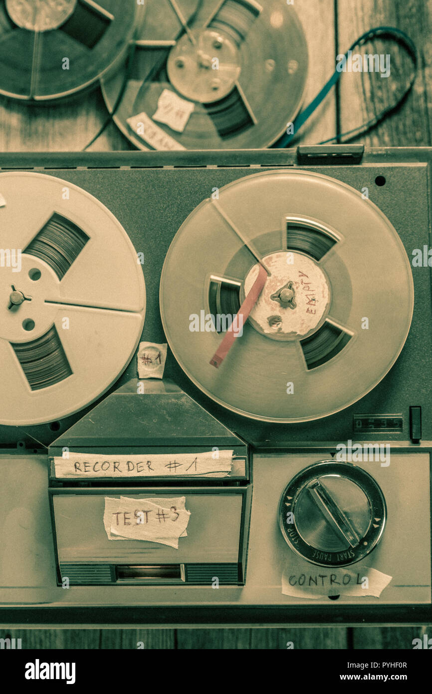 Classic reel-to-reel tape recorder with microphone and roll of tape ...